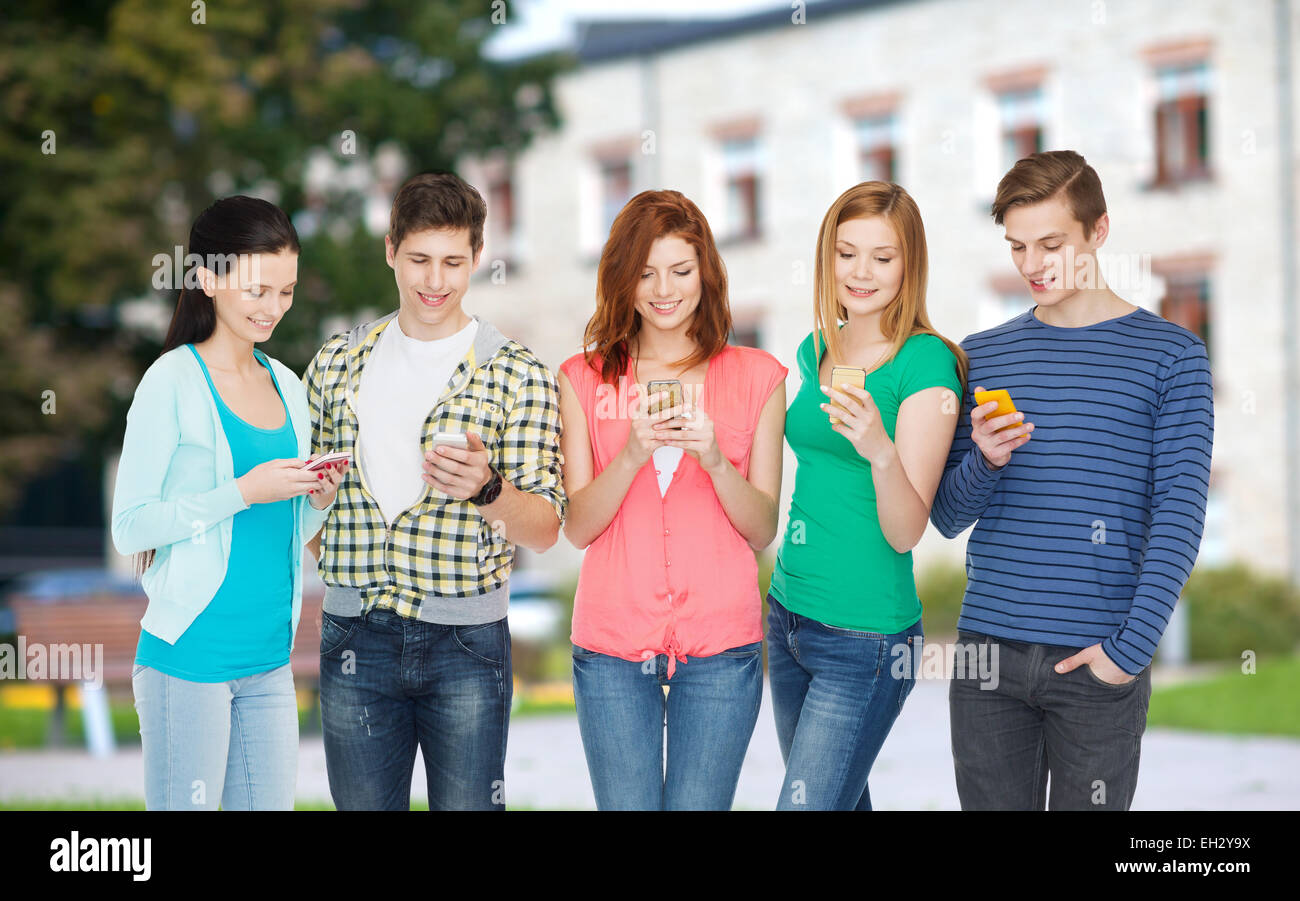 smiling students with smartphones Stock Photo - Alamy
