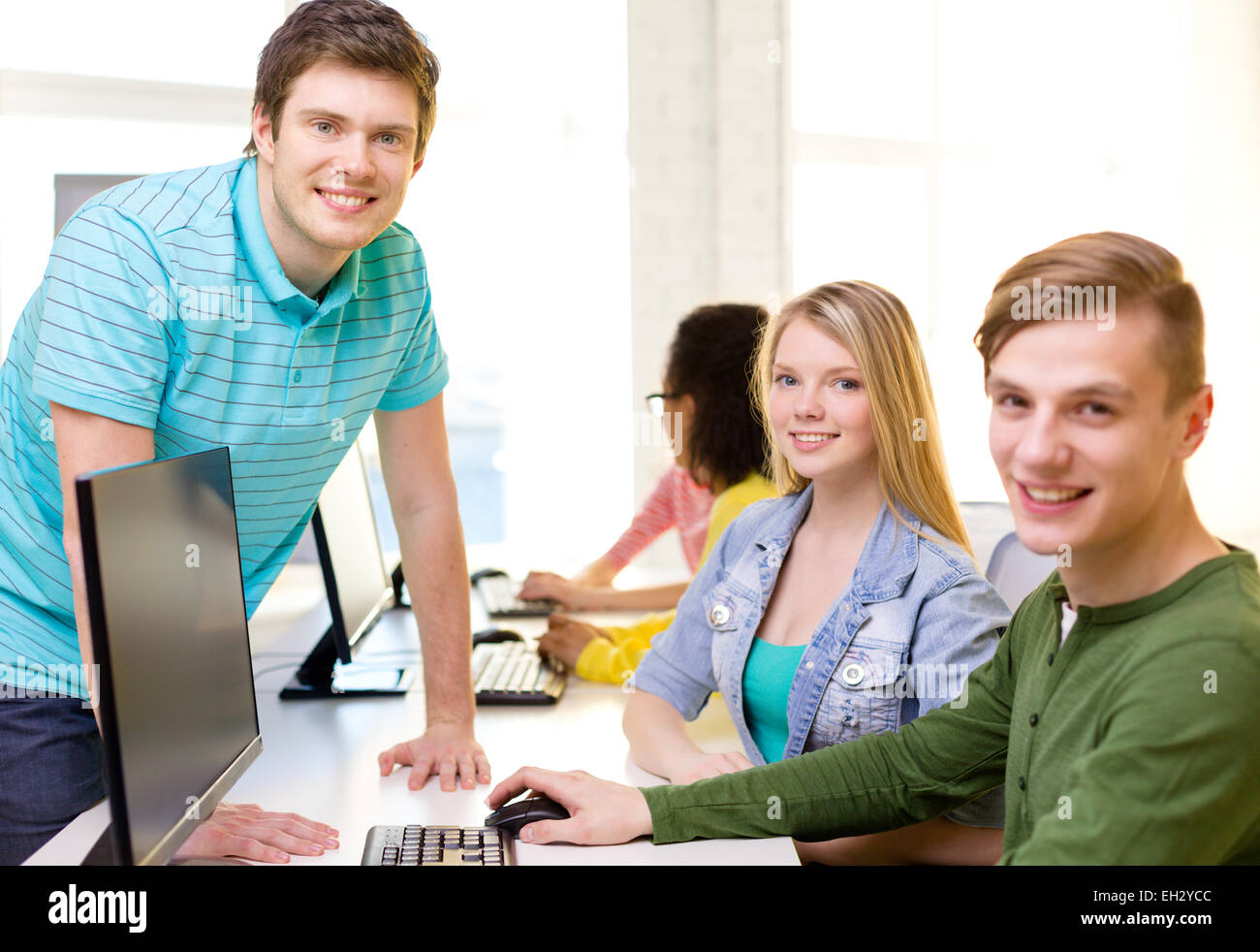group of smiling students in computer class Stock Photo - Alamy