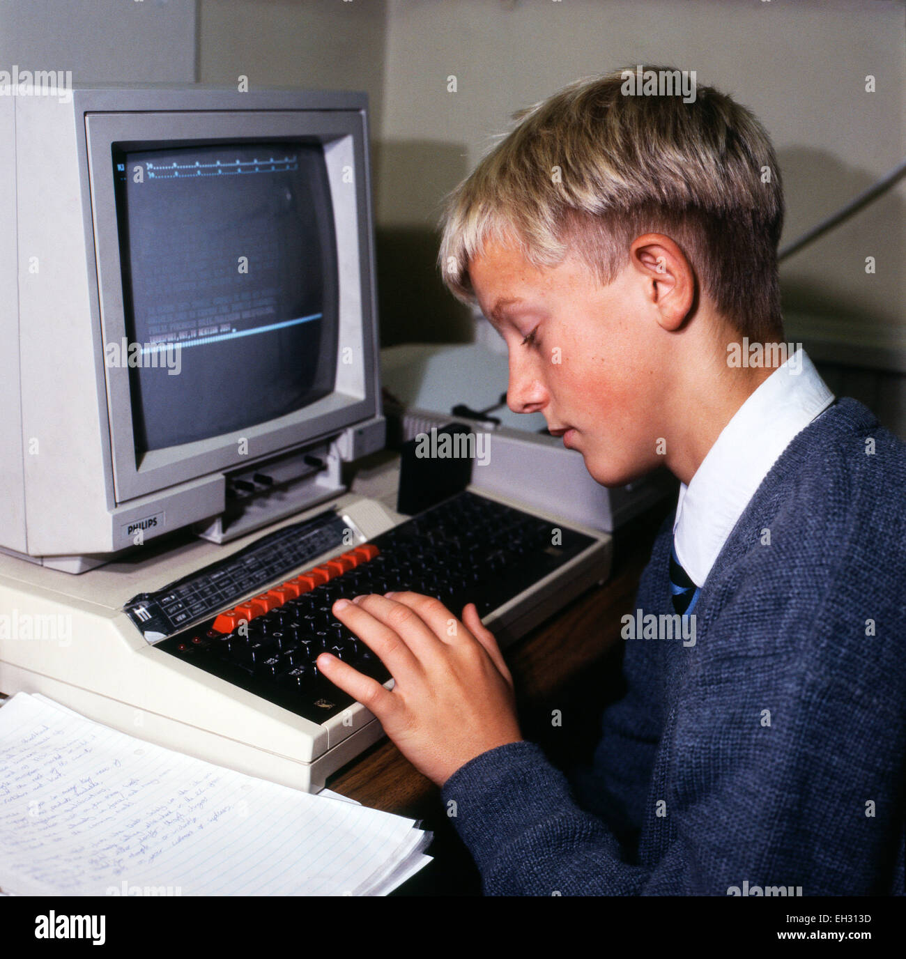 Teenage boy 1991 working at a computer monitor and keyboard in a school ...