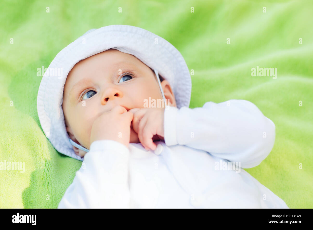 litle baby lying on floor and looking up Stock Photo - Alamy
