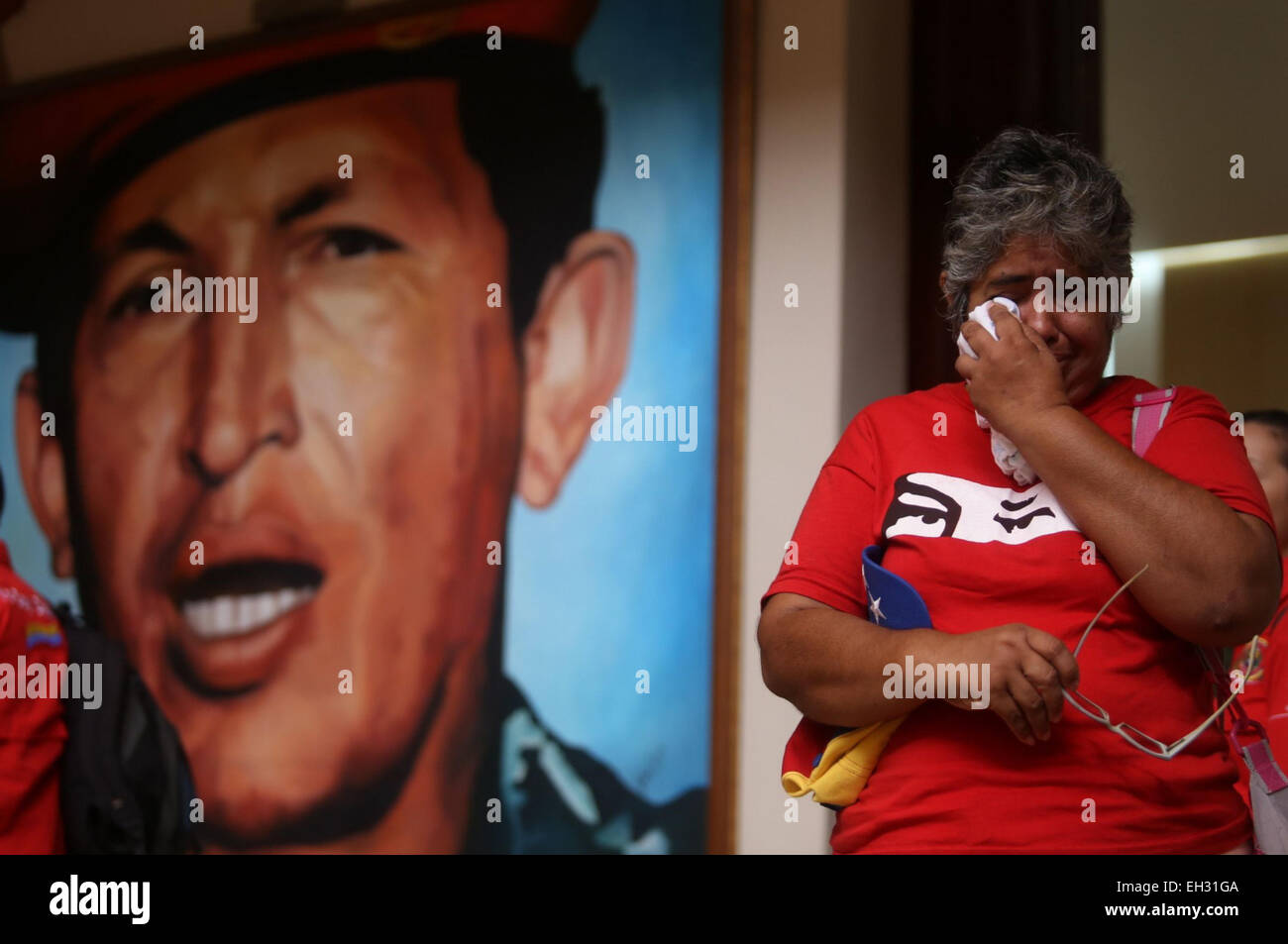Caracas. 5th Mar, 2015. A woman reacts in front of an picture of the ...