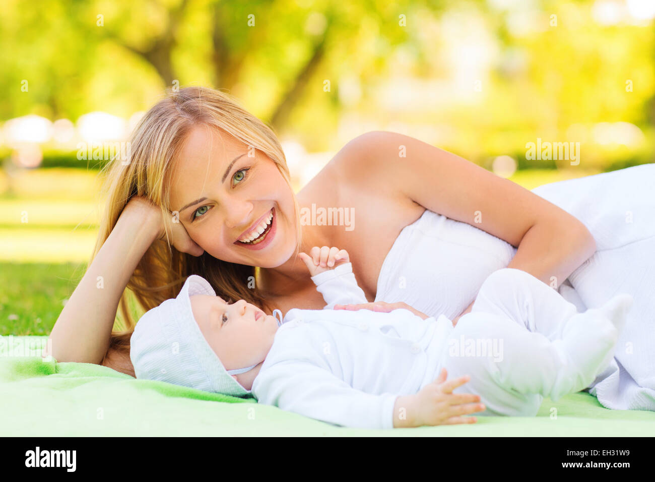 laughing mother lying with little baby on blanket Stock Photo - Alamy