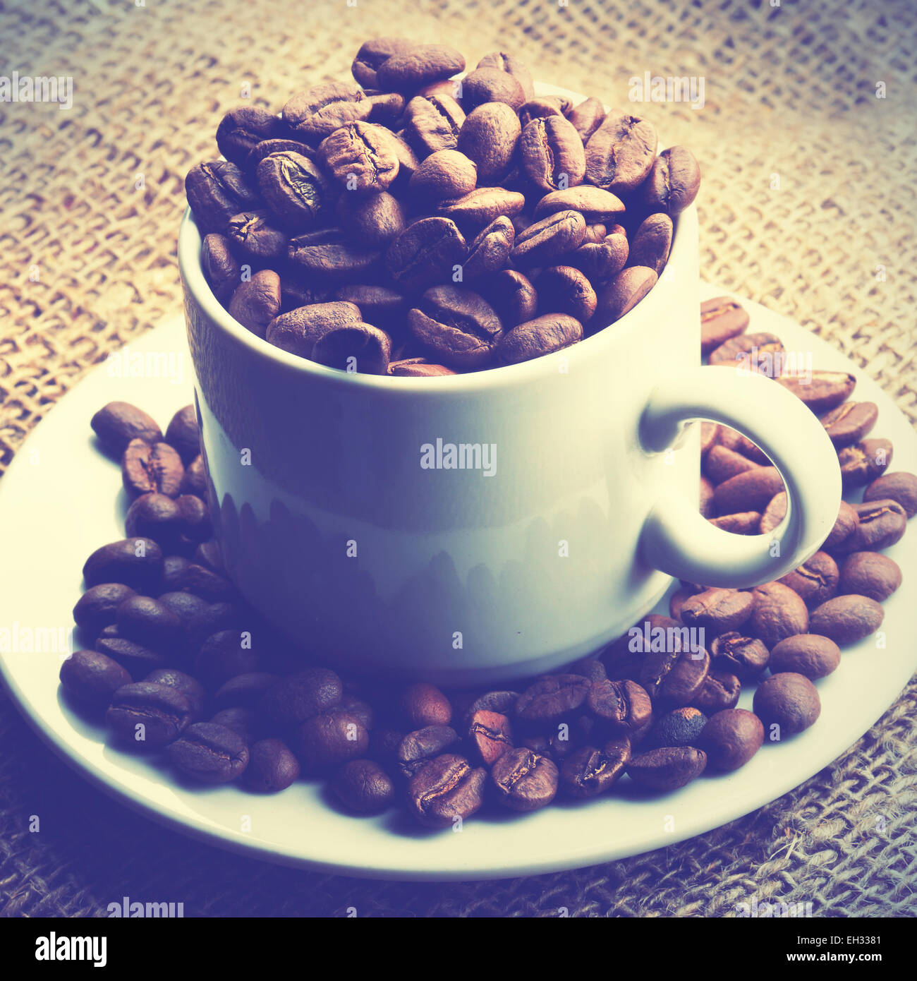 Cup full of coffee beans. Retro style filtred image Stock Photo - Alamy