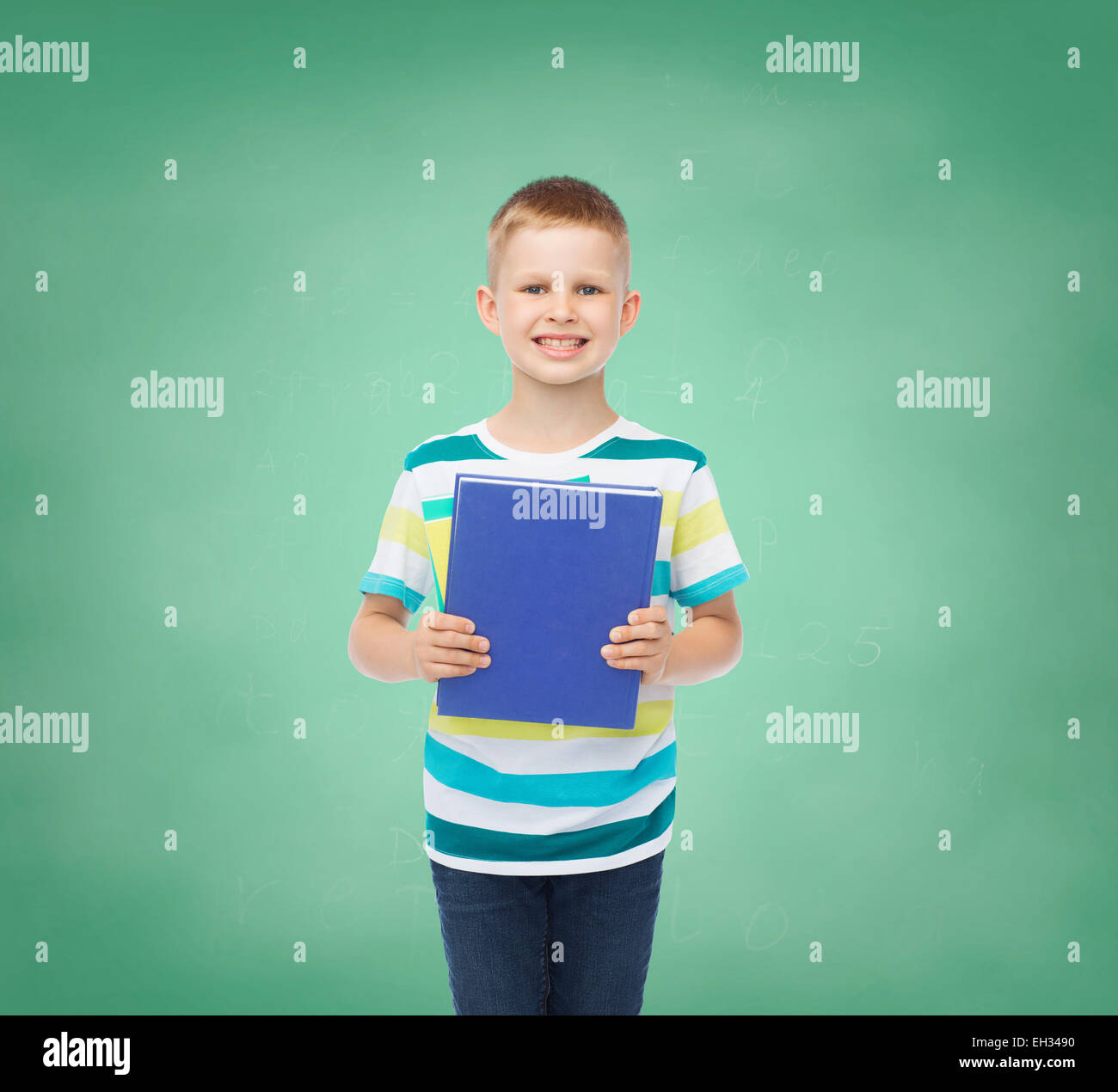 smiling little student boy with blue book Stock Photo - Alamy