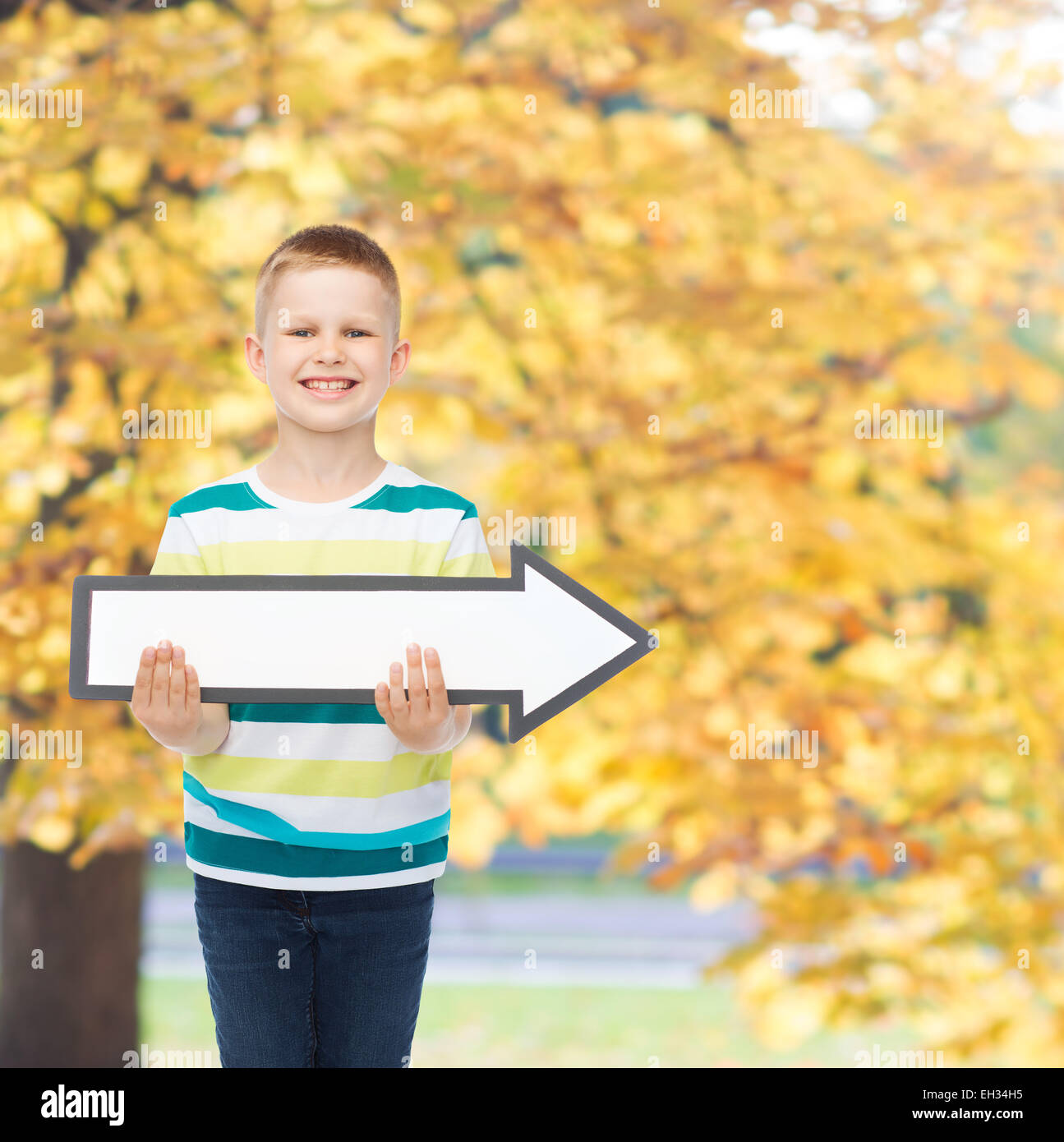 smiling little boy with blank arrow pointing right Stock Photo - Alamy