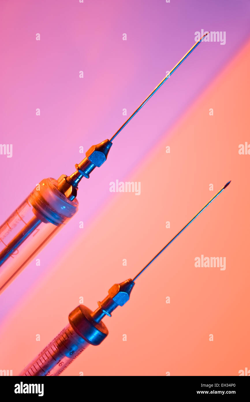 old glass syringe multicolored lights Stock Photo - Alamy