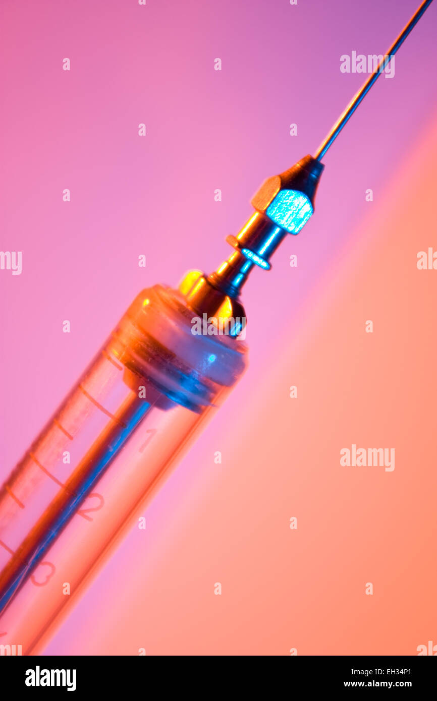 old glass syringe multicolored lights Stock Photo - Alamy