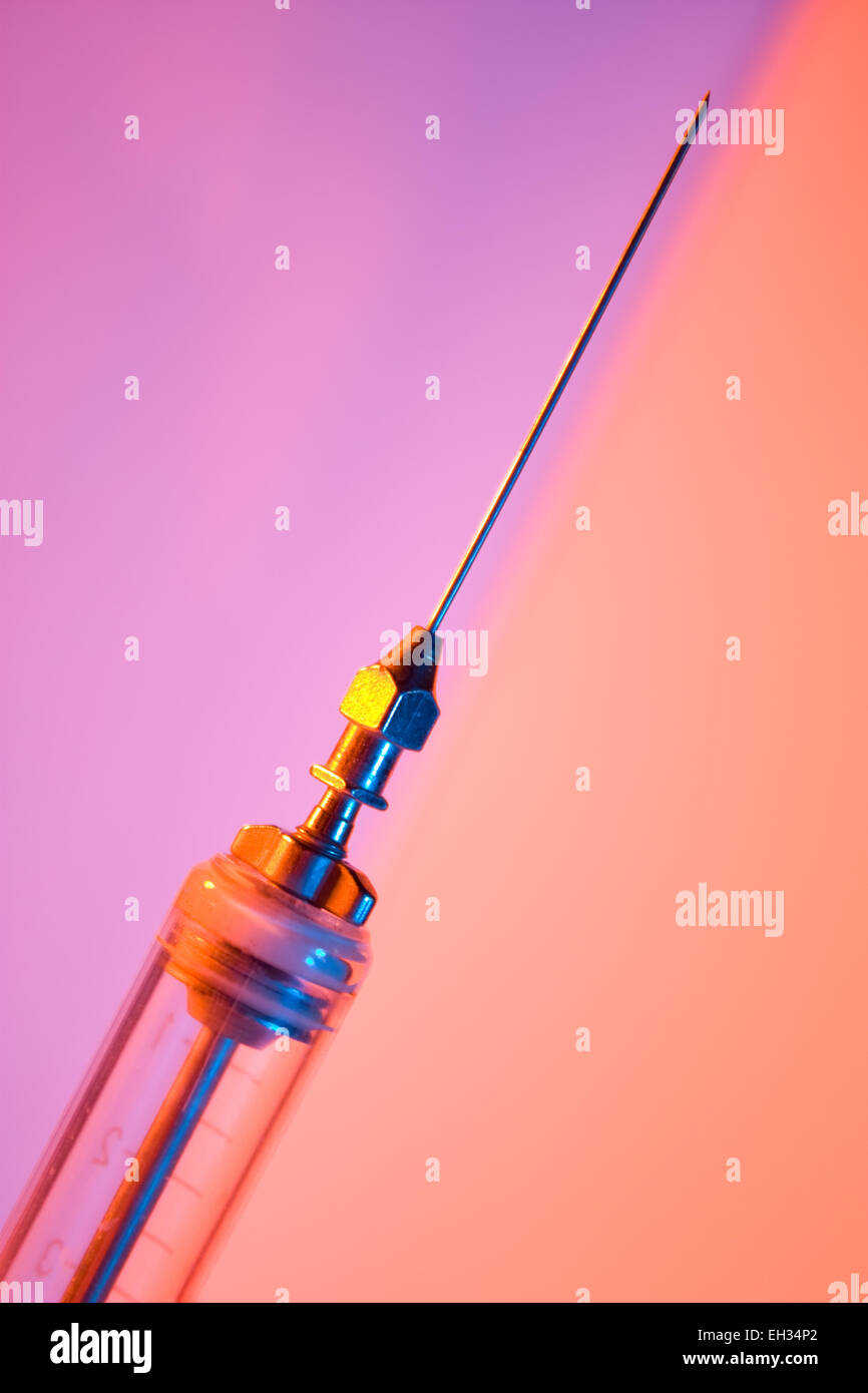 old glass syringe multicolored lights Stock Photo - Alamy