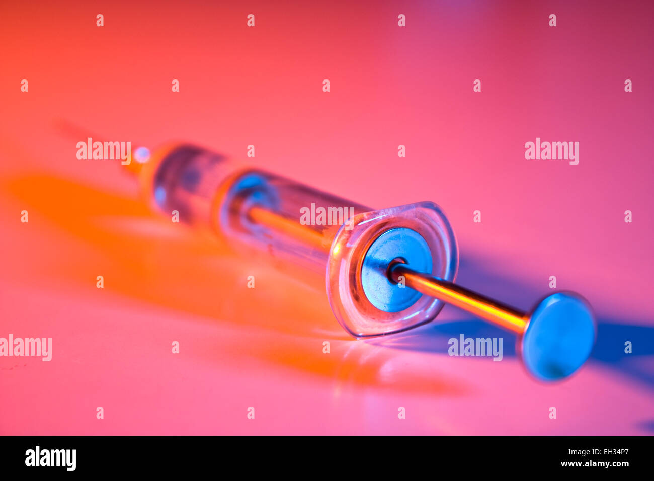 old glass syringe multicolored lights Stock Photo - Alamy