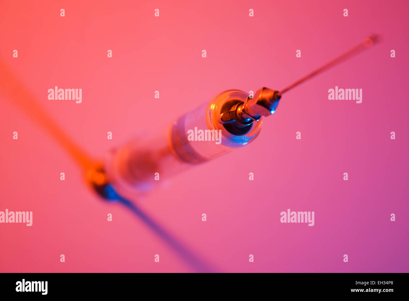 old glass syringe multicolored lights Stock Photo - Alamy