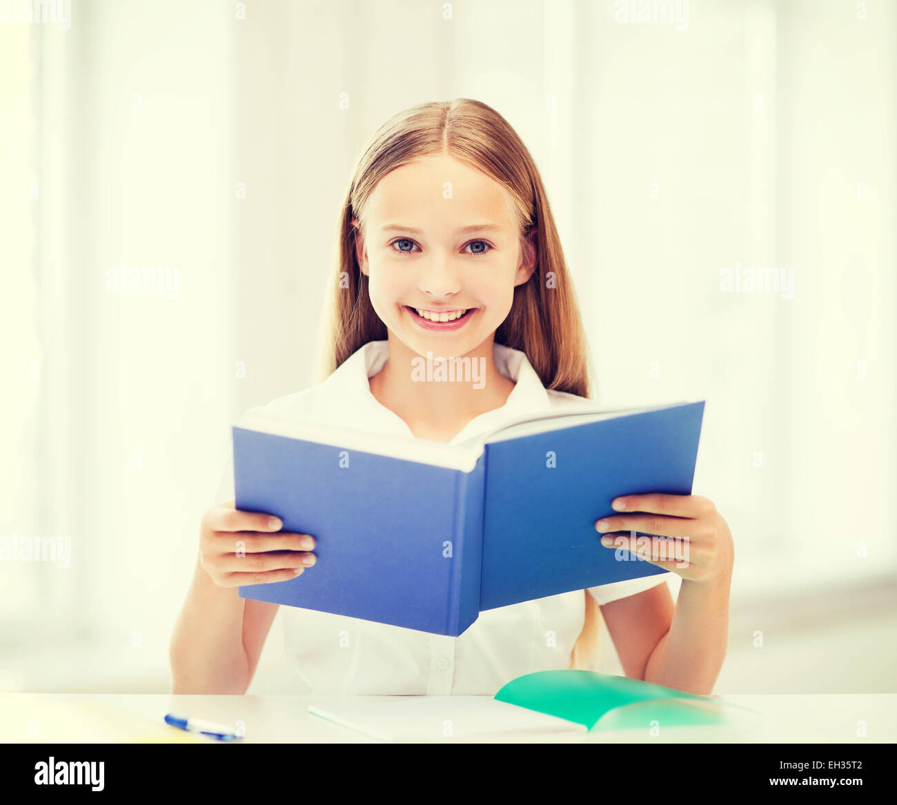 girl studying and reading book at school Stock Photo - Alamy