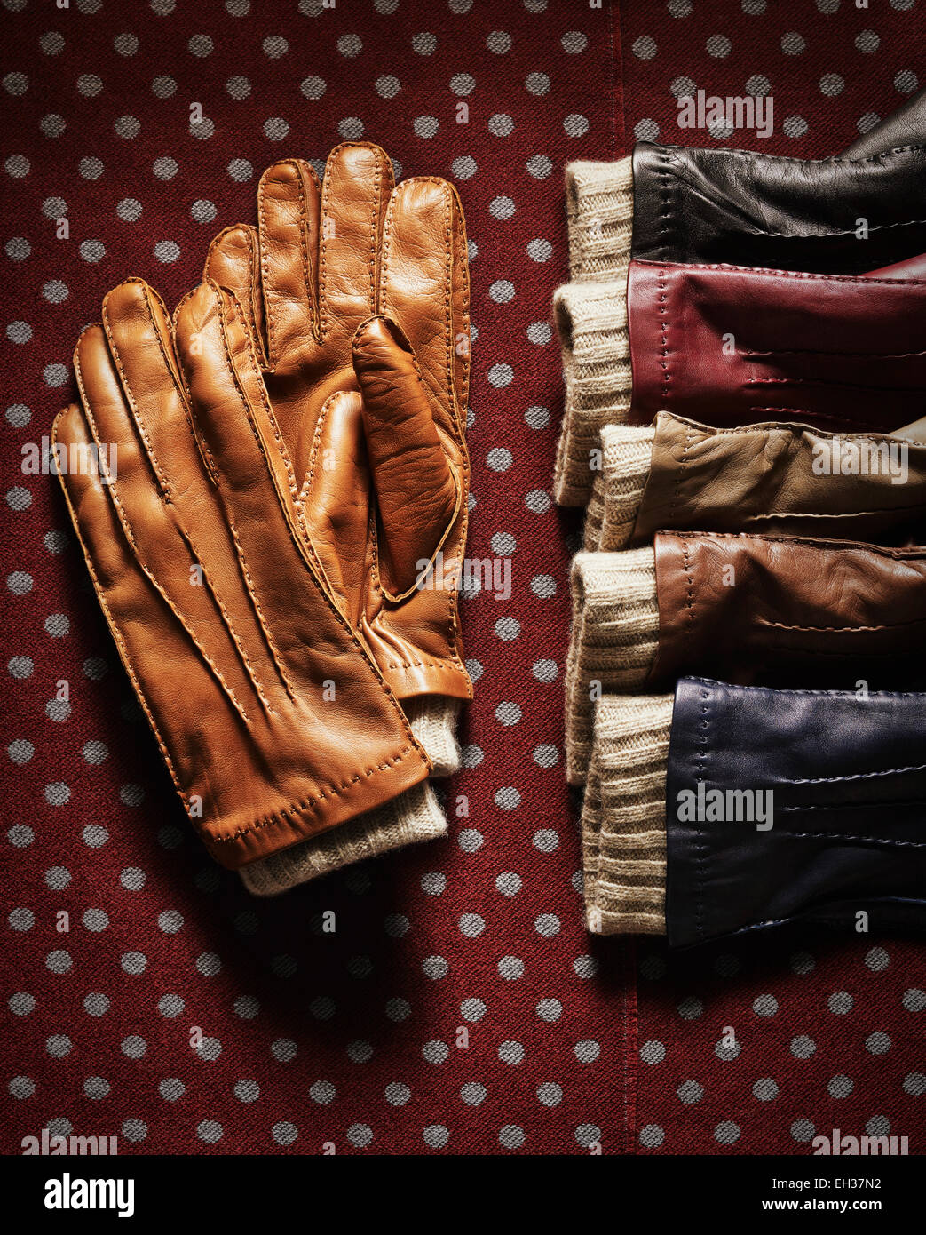 Leather Gloves in different colours on Dotted Red Fabric, Studio Shot ...