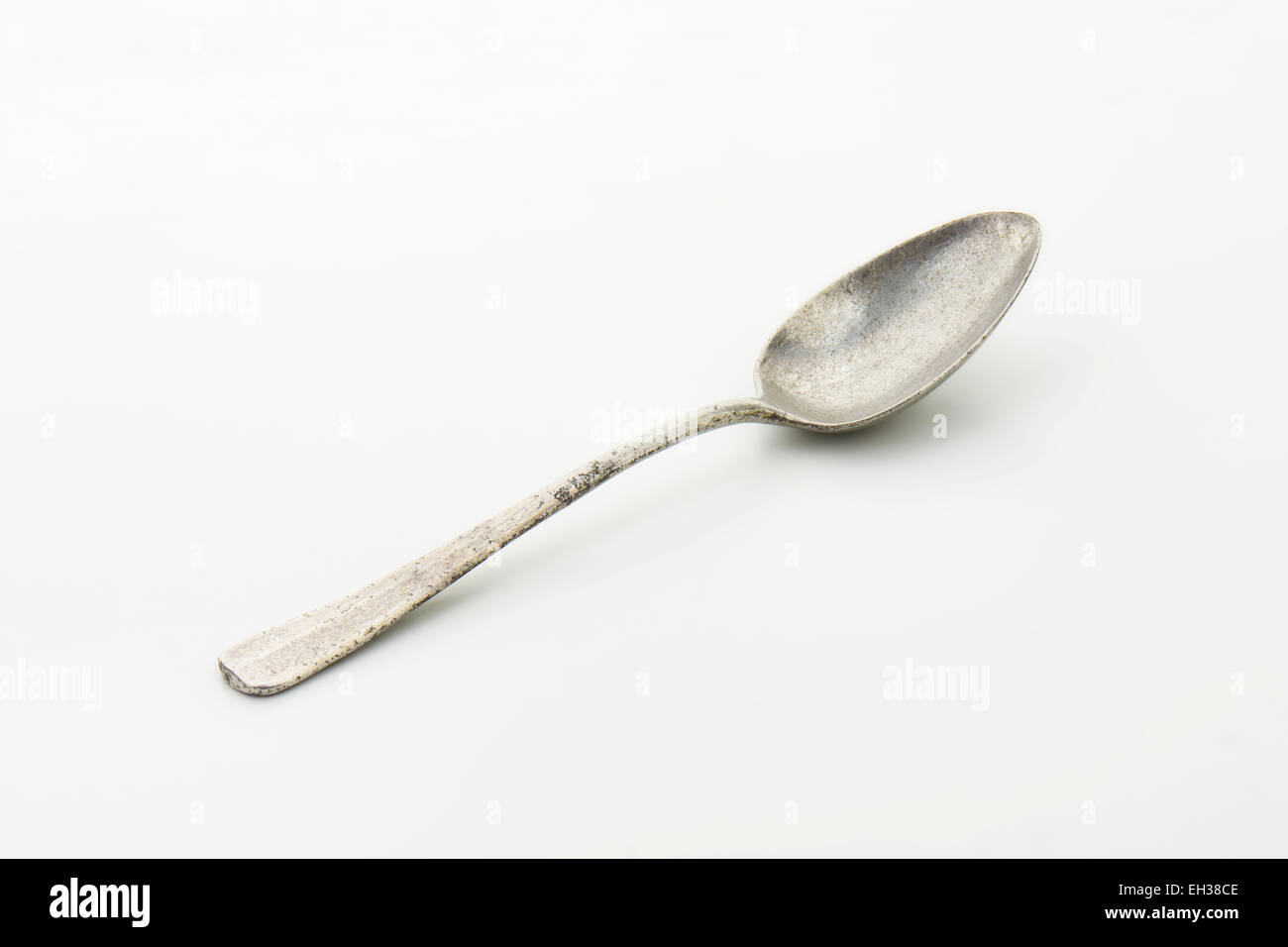 Old silver tea spoon on white background Stock Photo - Alamy