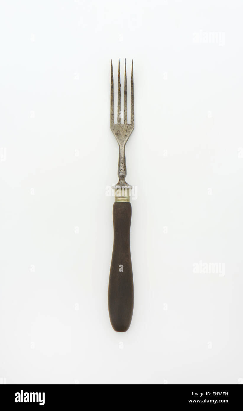 Old silver fork with black handle on white background Stock Photo - Alamy