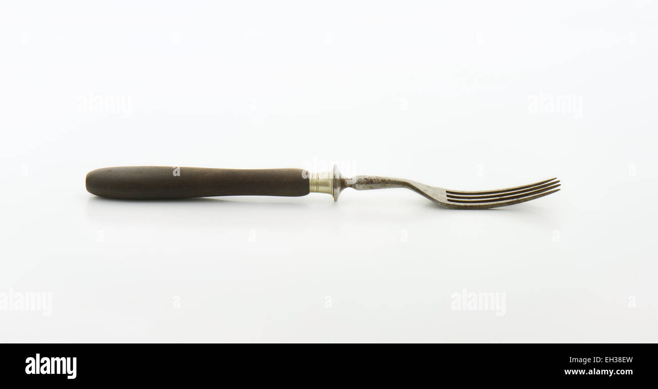 Old silver fork with black handle on white background Stock Photo - Alamy