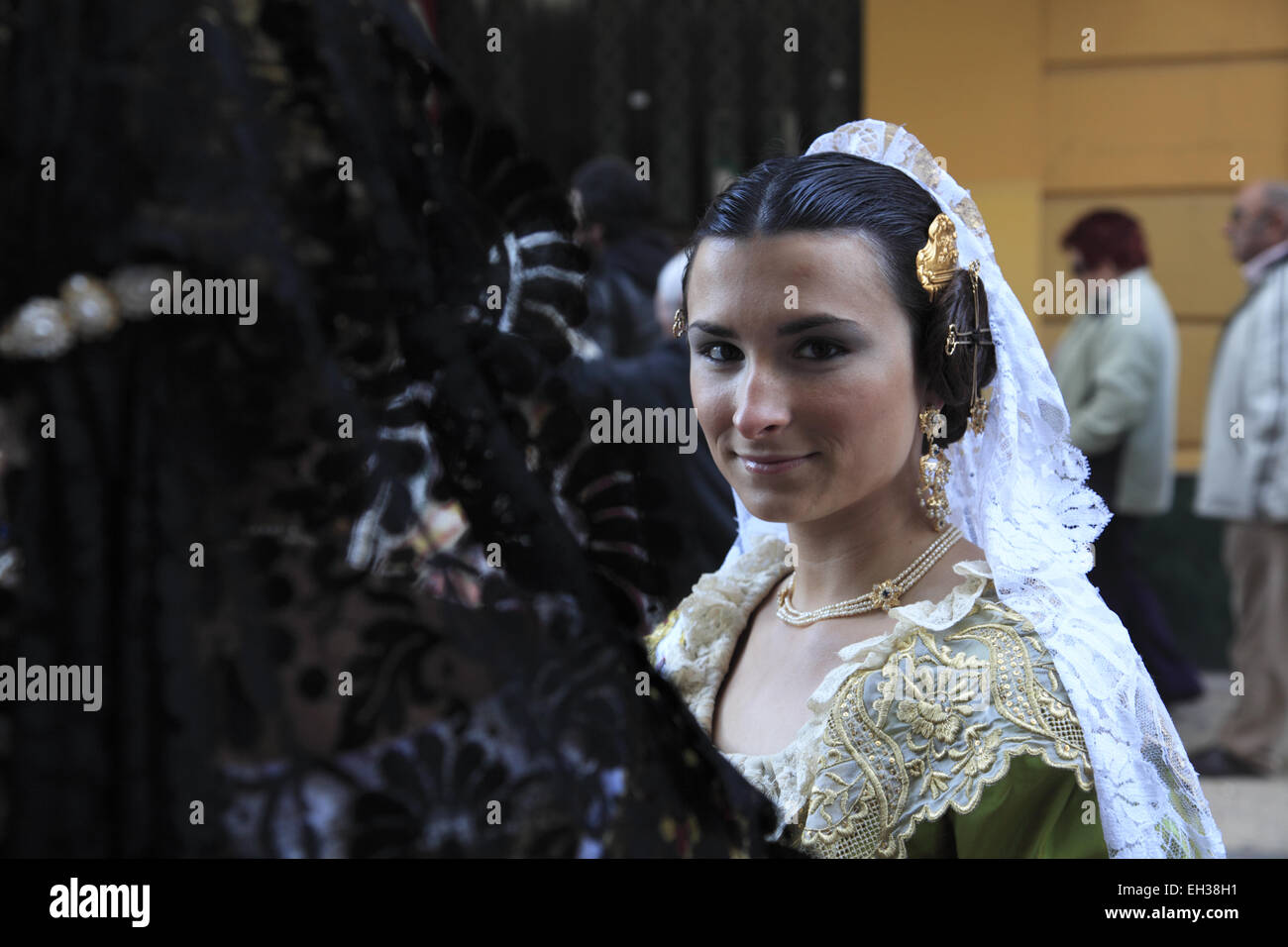 A young lady dressed in traditional las Fallas costumes and headpiece ...