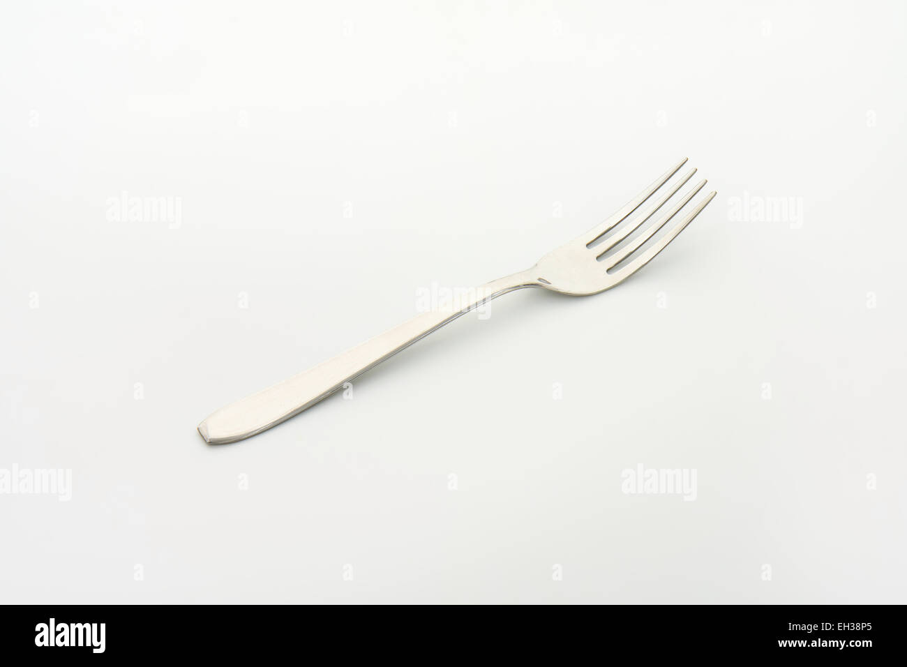 One metal fork on white background Stock Photo - Alamy