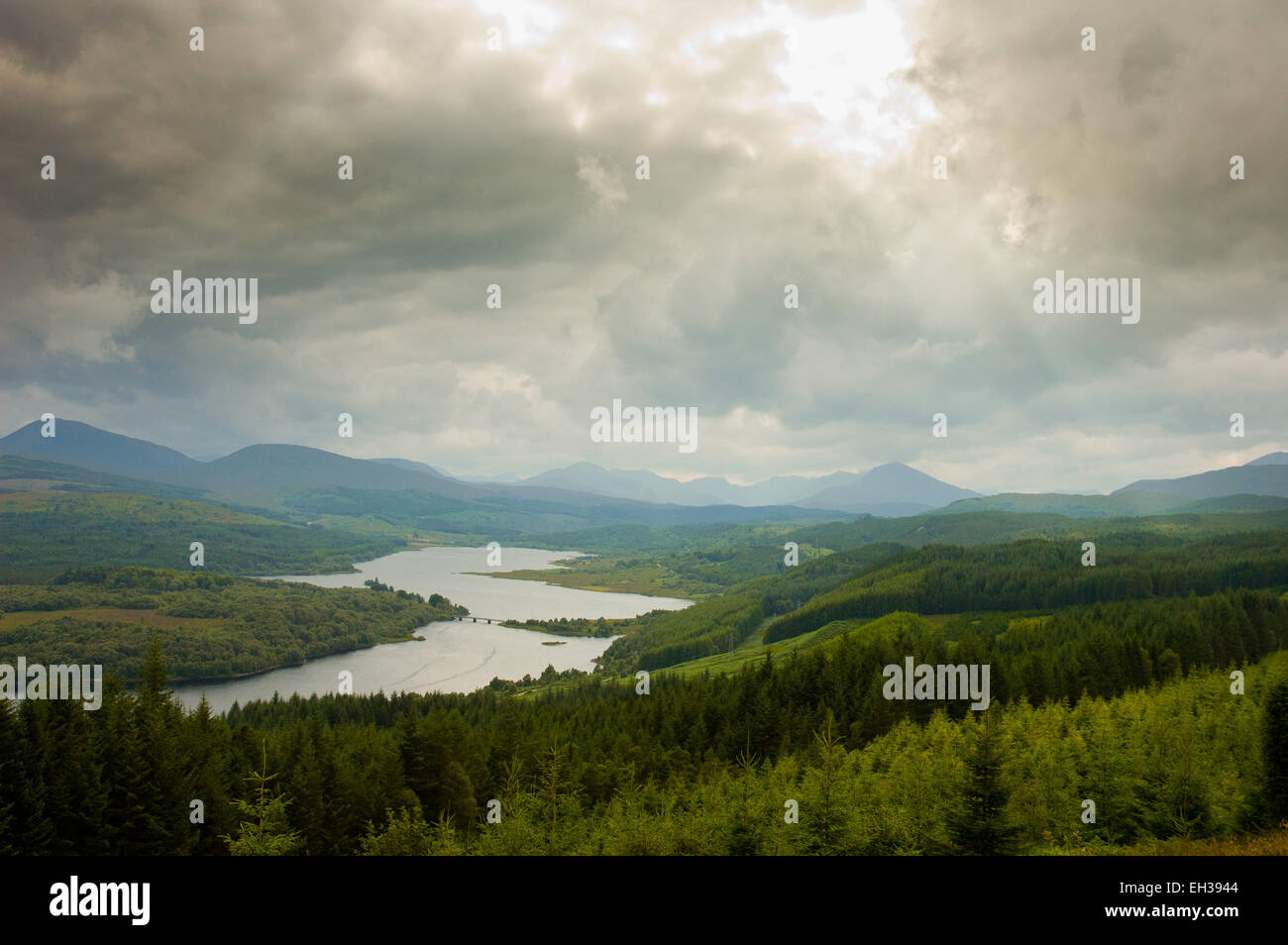 Aerial view of Scotland, highlands, lake and green forest with dramatic ...