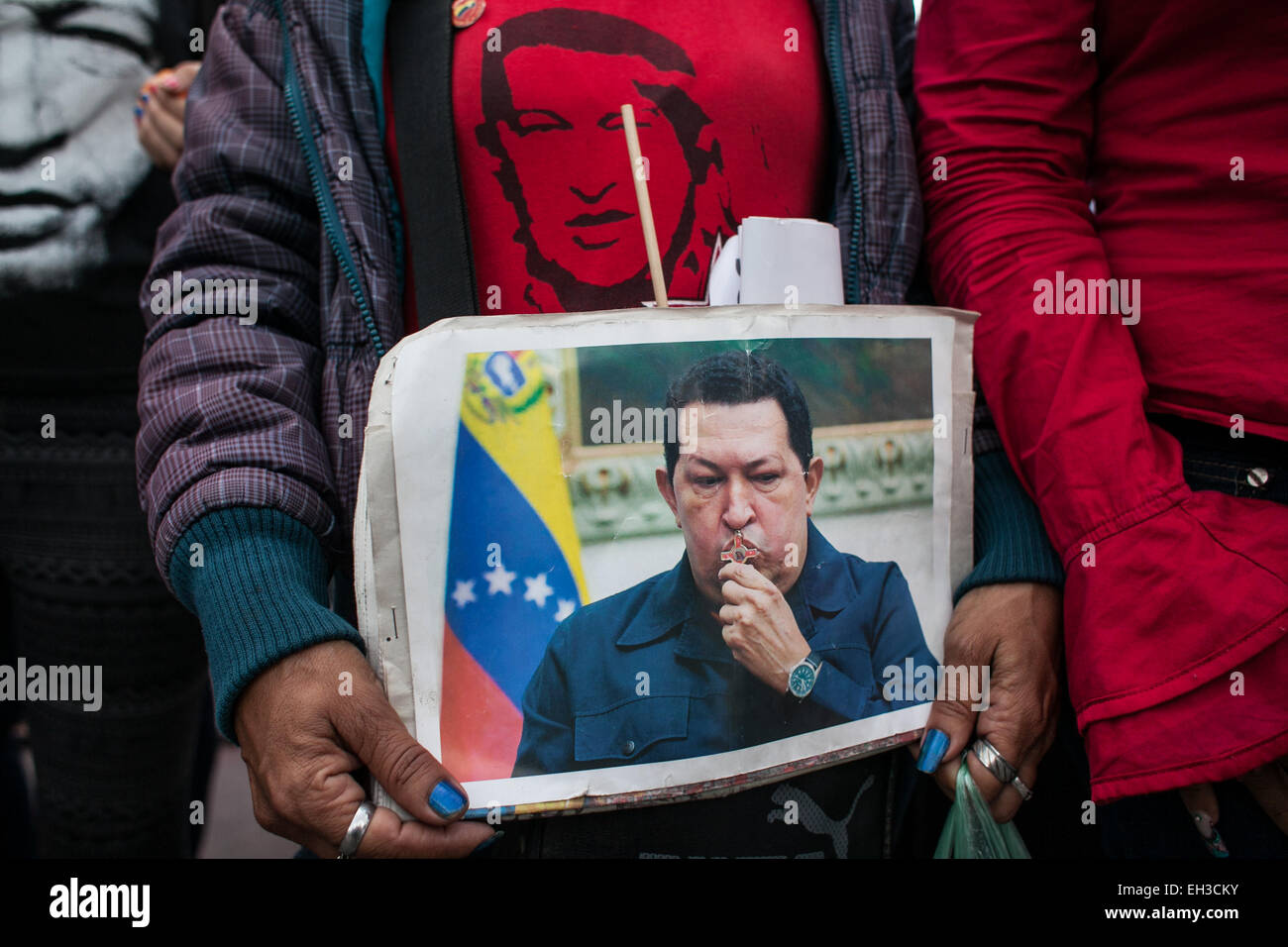 Caracas. 5th Mar, 2015. A woman holds a image of late Venezuelan ...
