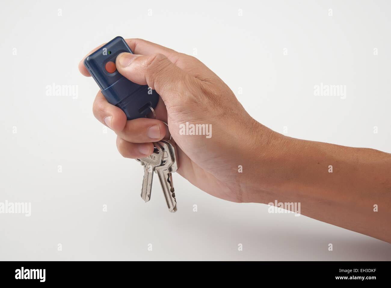 Hand press the remote control with keys in clean background Stock Photo ...