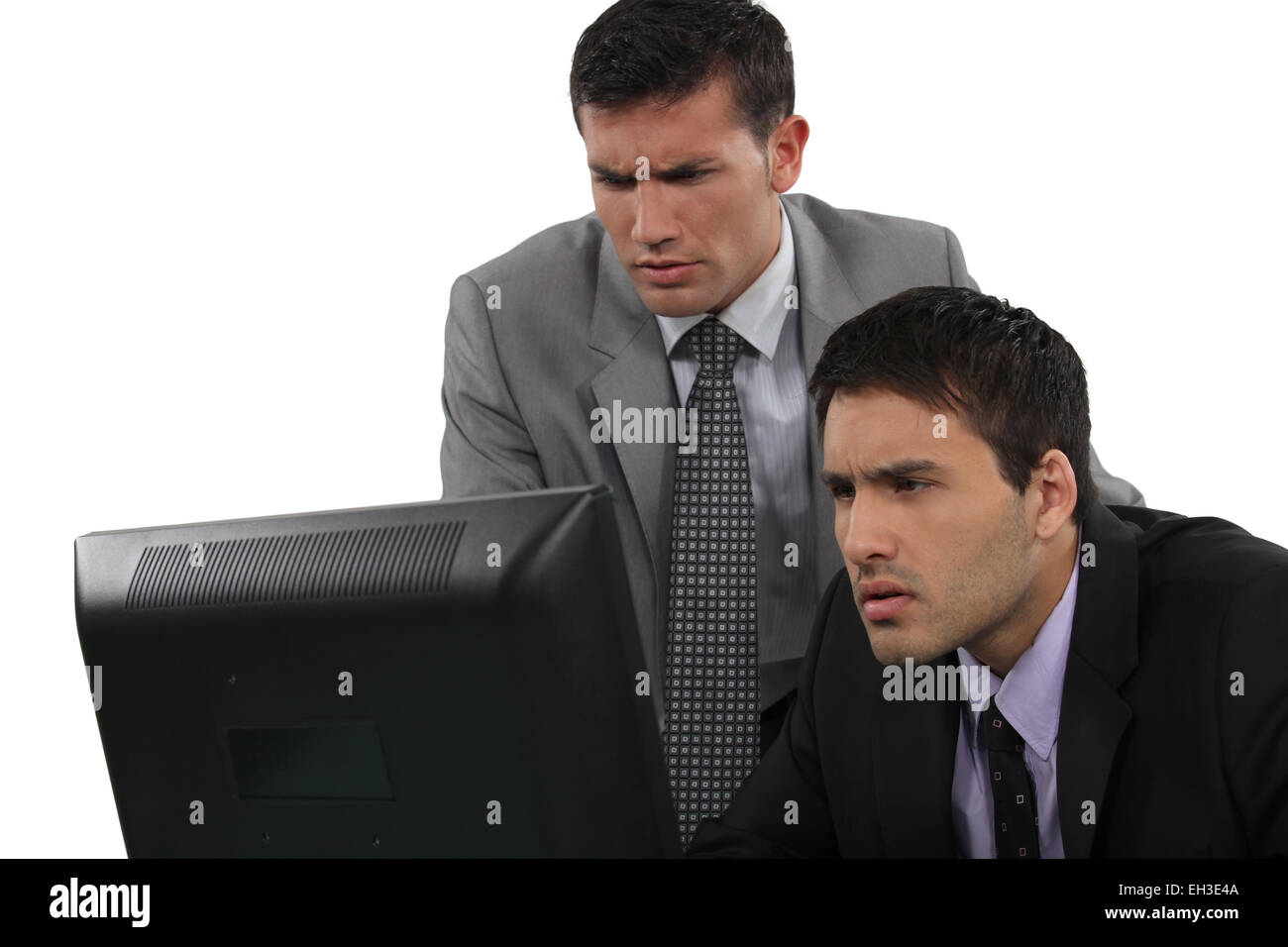Two serious businessman concentrating Stock Photo - Alamy