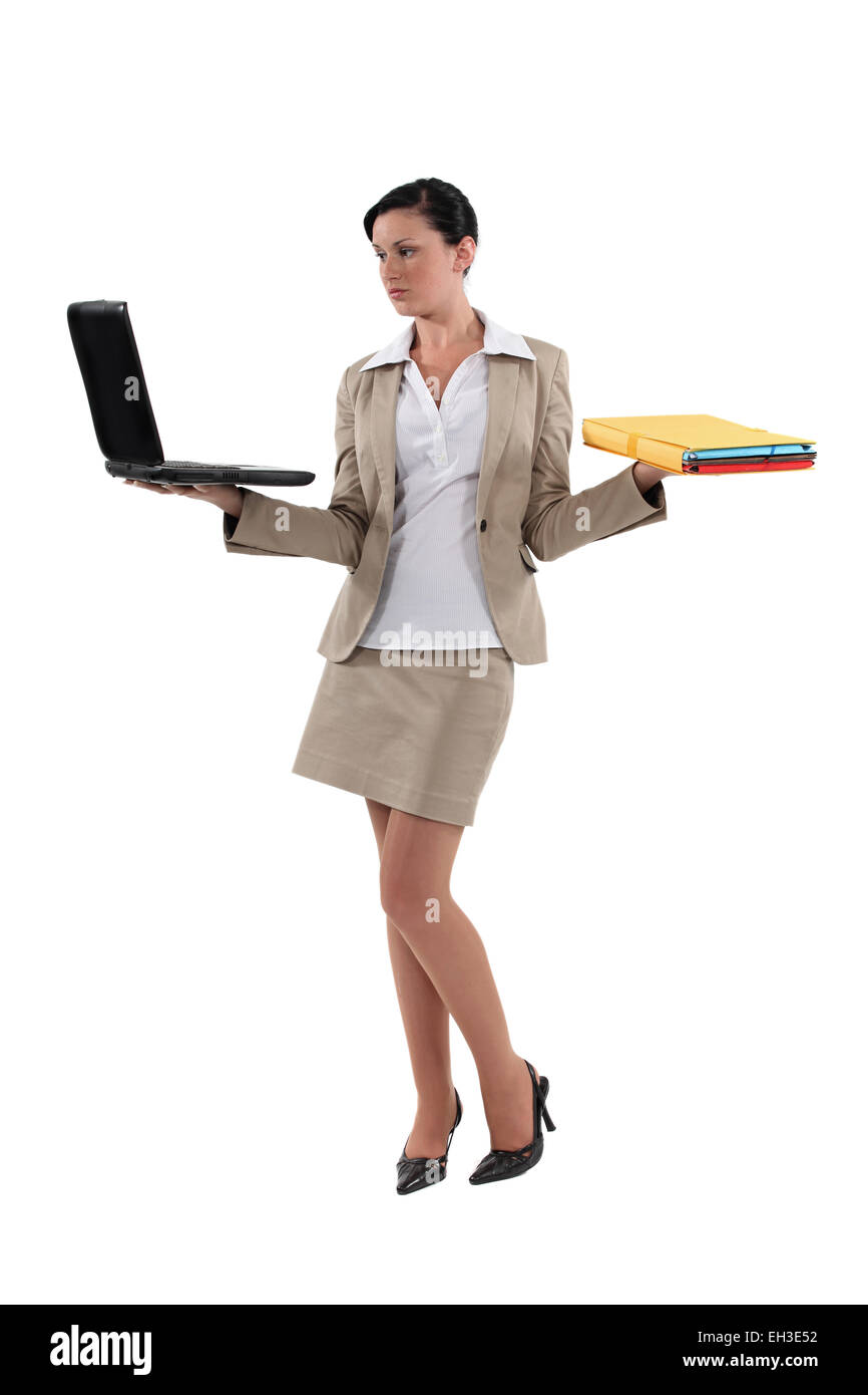 Woman carrying laptop and folders Stock Photo - Alamy