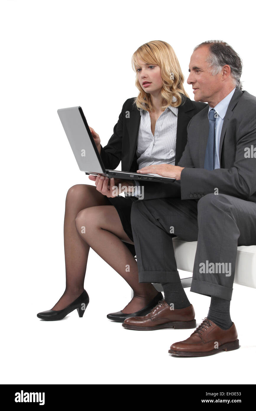 Boss and employee looking at laptop Stock Photo - Alamy