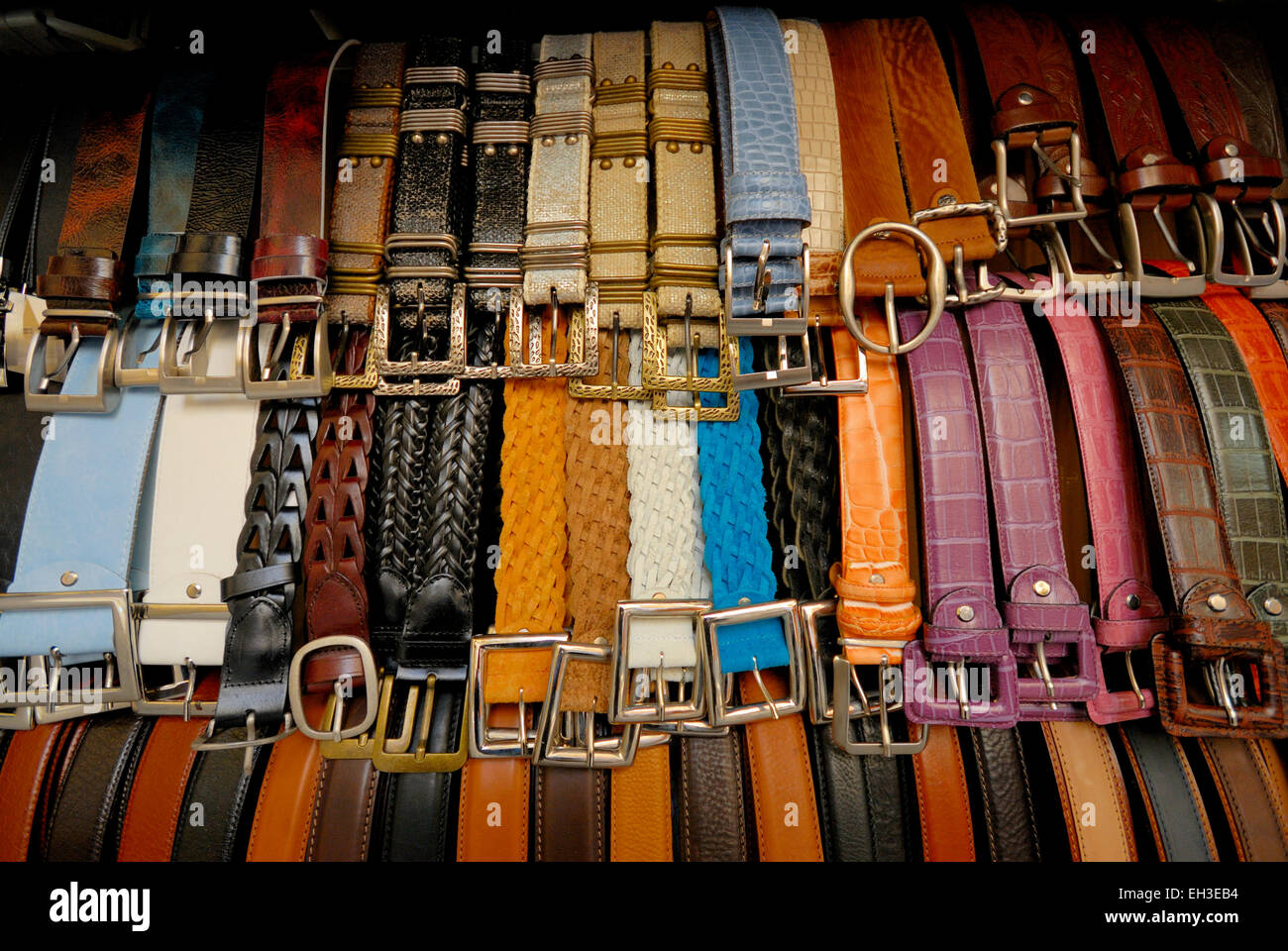 Belts for sale on a leather stall in a city centre market, Florence ...