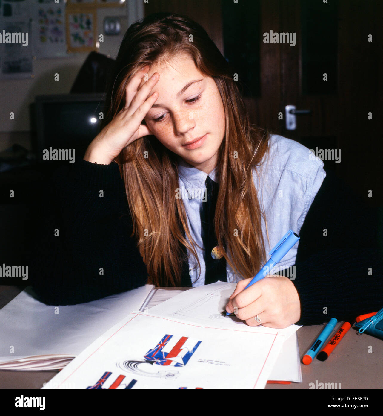 Teenage girl student writing and drawing working on a design project in ...