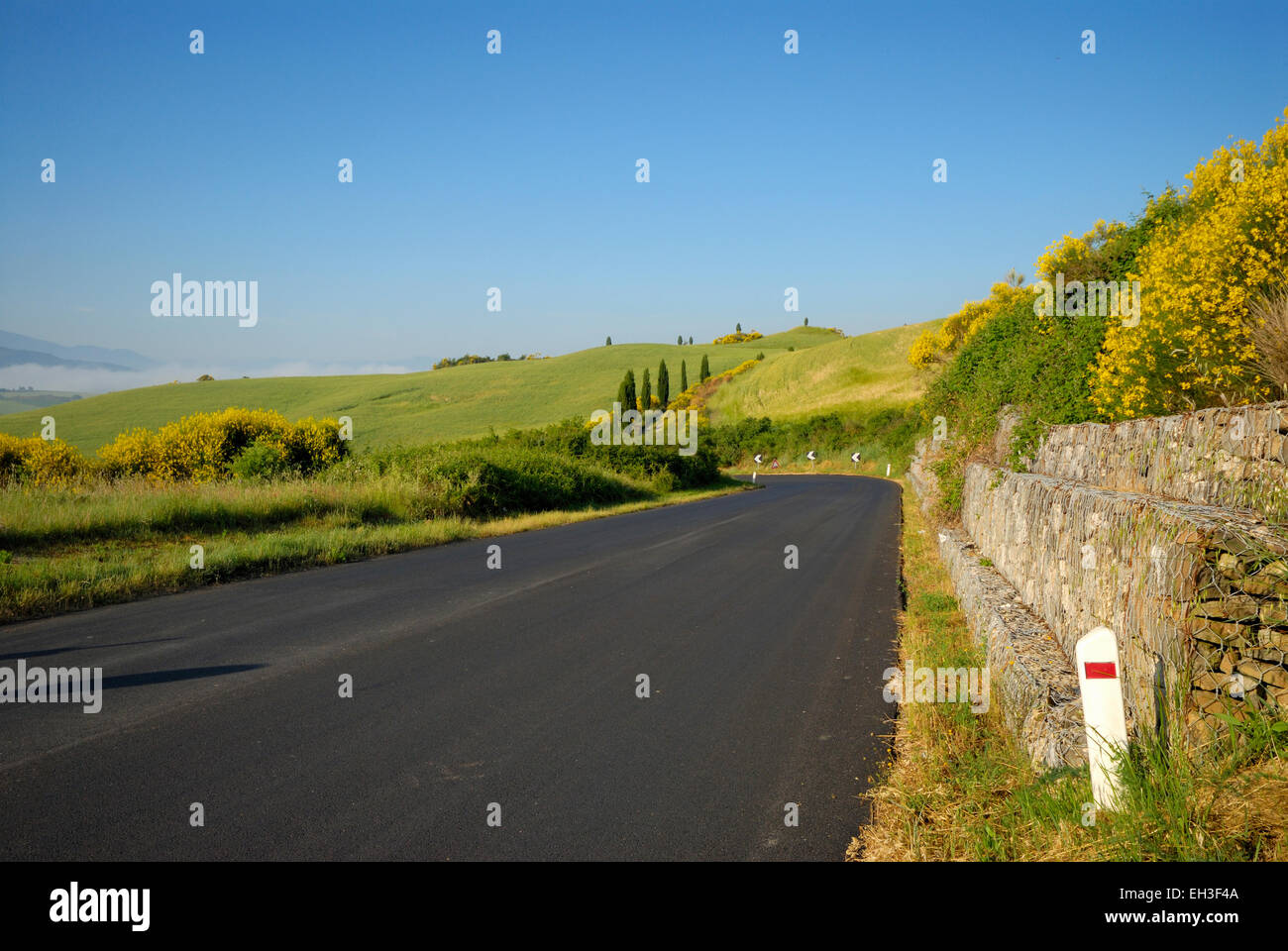 Milestone and highway through landscape, Tuscany, Italy Stock Photo - Alamy
