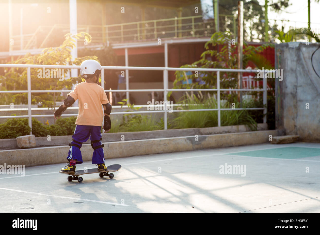 A kid on a skateboard in sunset at Play Arena skate park in Bangalore ...