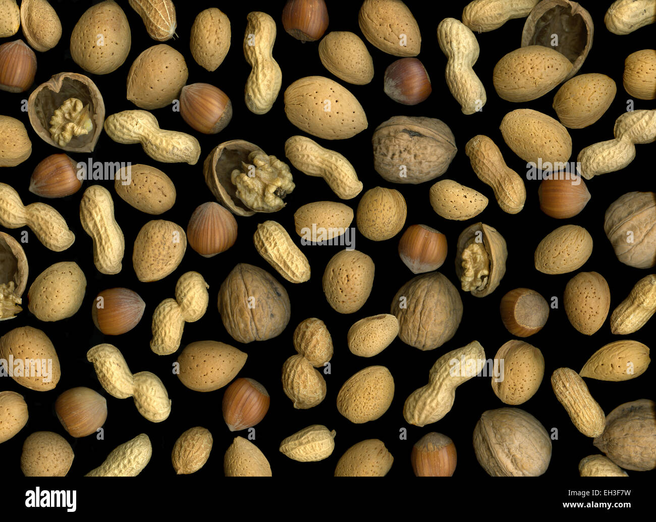 Mixed nuts isolated on black background Stock Photo - Alamy