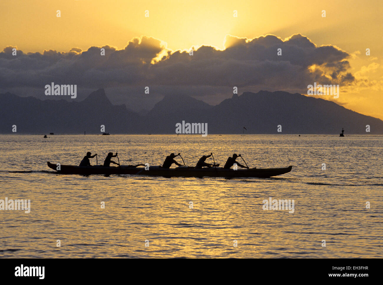 Native polynesians in outrigger canoe at sunset, Bora-Bora, Tahiti ...