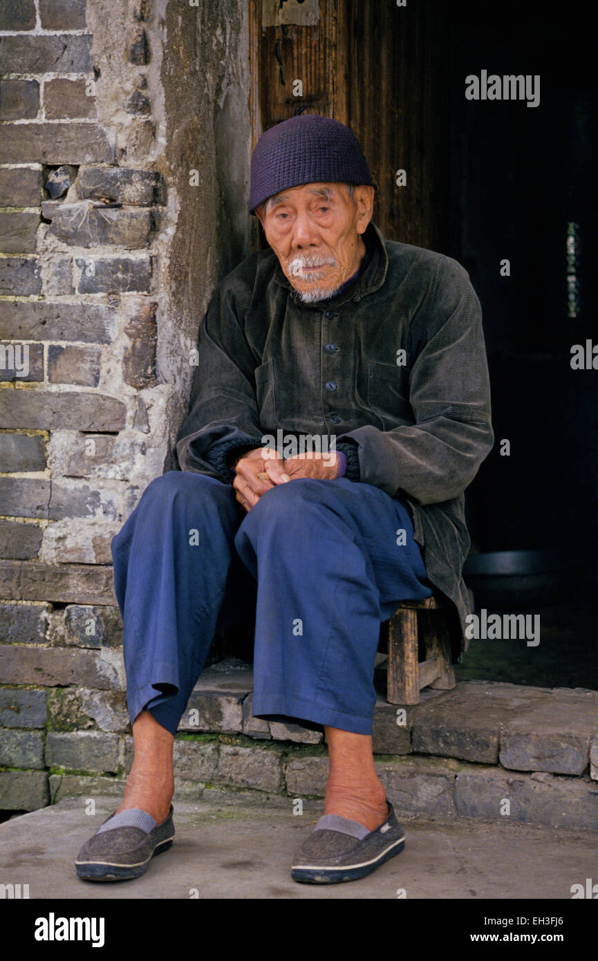 Old man sitting in doorway, Beijing, China Stock Photo - Alamy