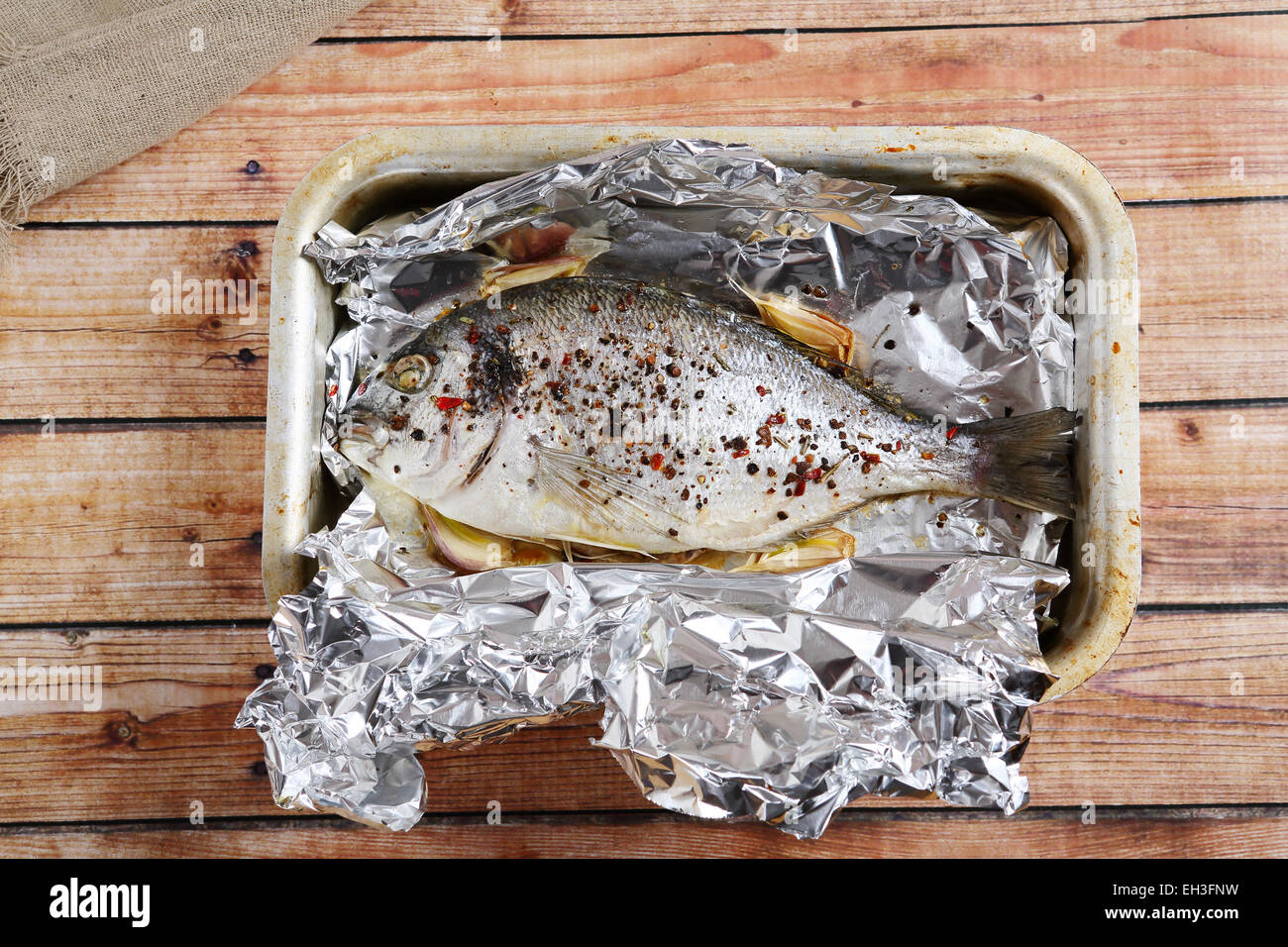 Cooked dorado on the foil, food Stock Photo - Alamy