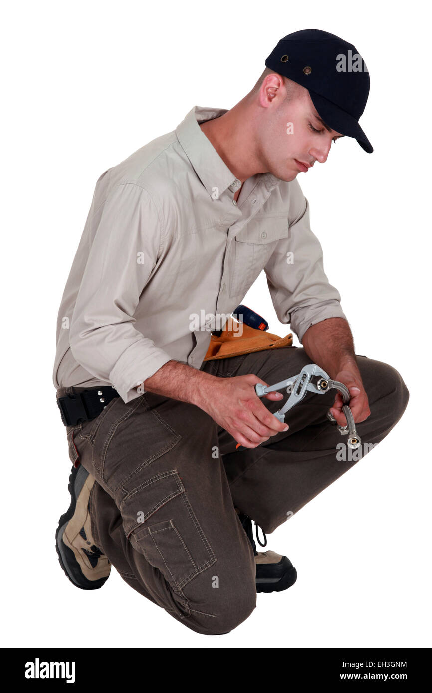 Plumber with a pair of grips Stock Photo - Alamy