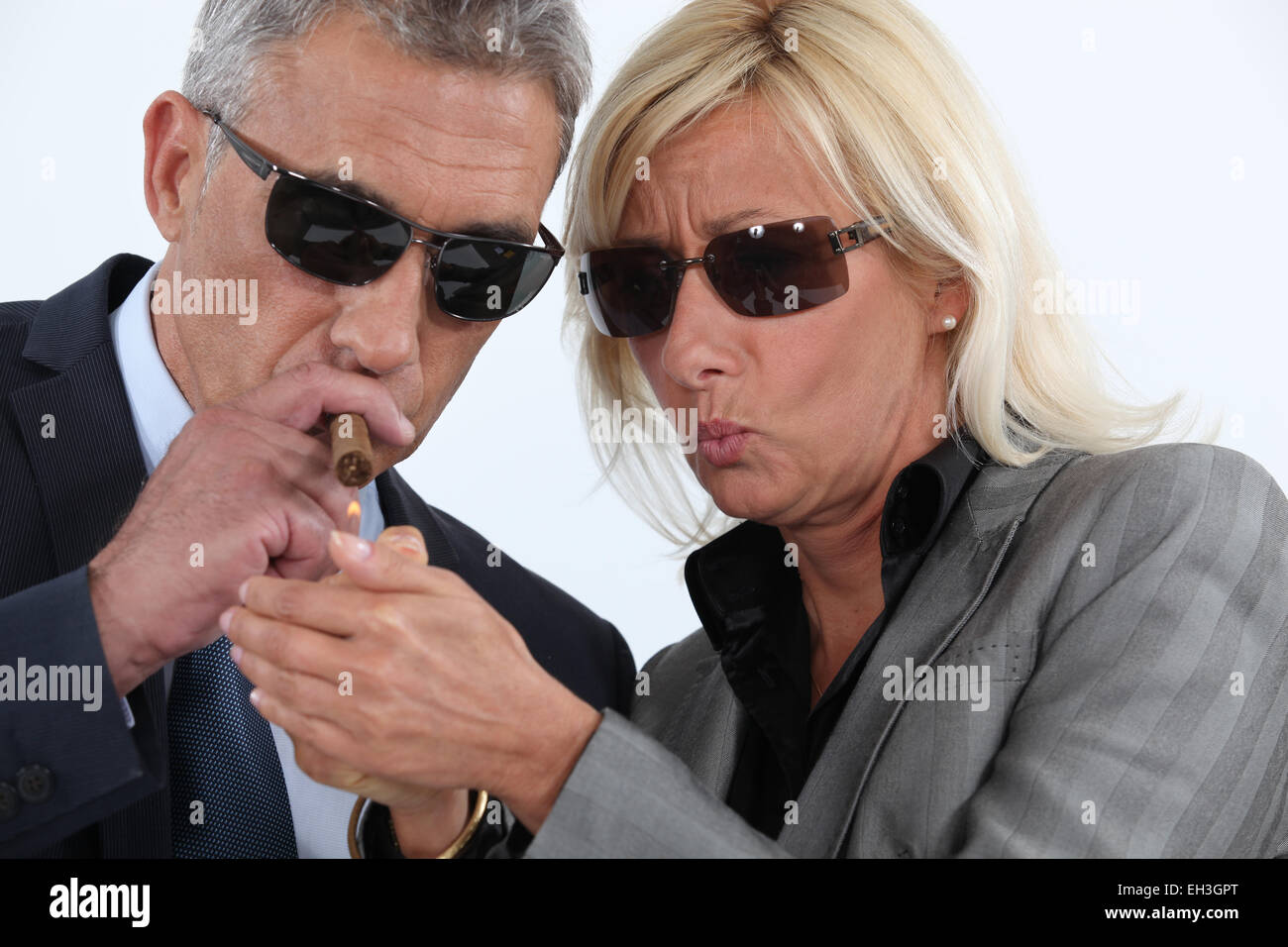 Man lighting cigar Stock Photo - Alamy