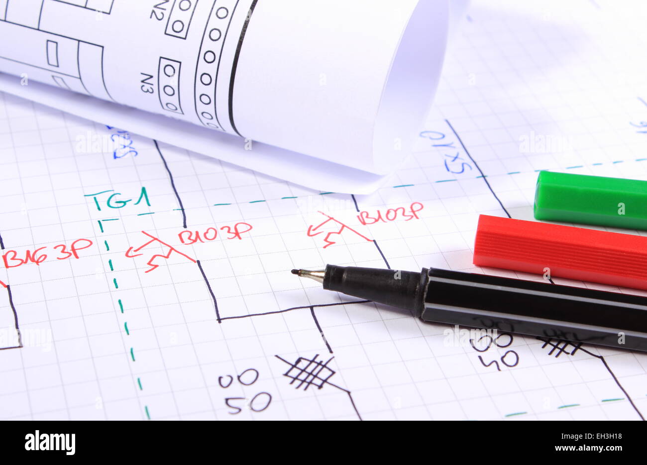 Rolls of electrical diagrams and accessories for drawing lying on ...