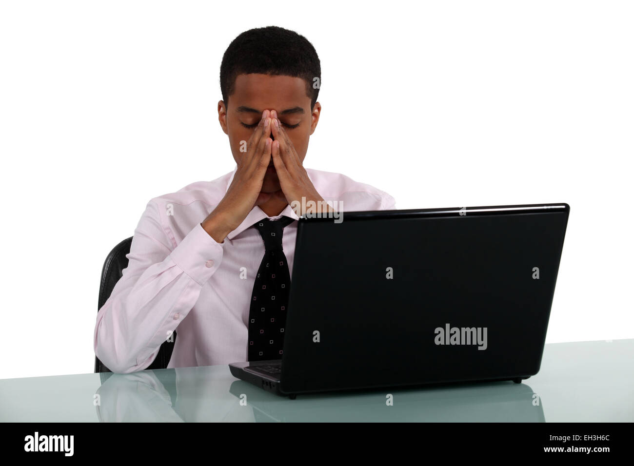 Stressed man sat at desk Stock Photo - Alamy