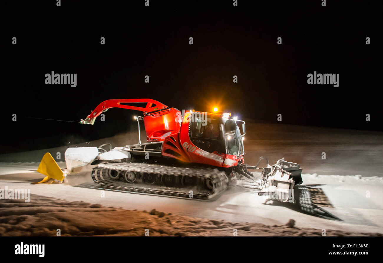 Snowcat planing ski slope with rope at night, Austria Stock Photo - Alamy