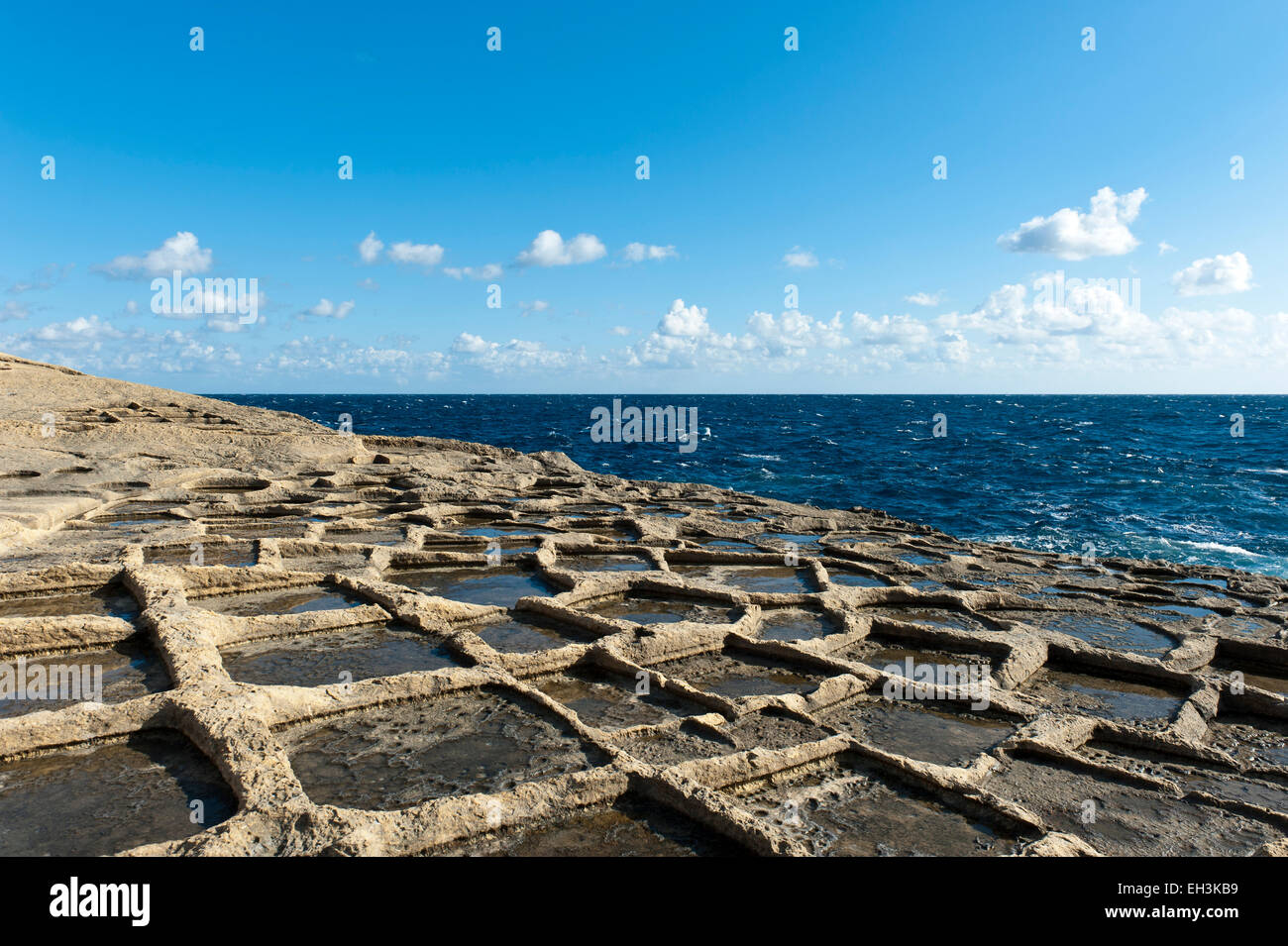 Sandstone formations on the coast, sea salt extraction in salt pans ...