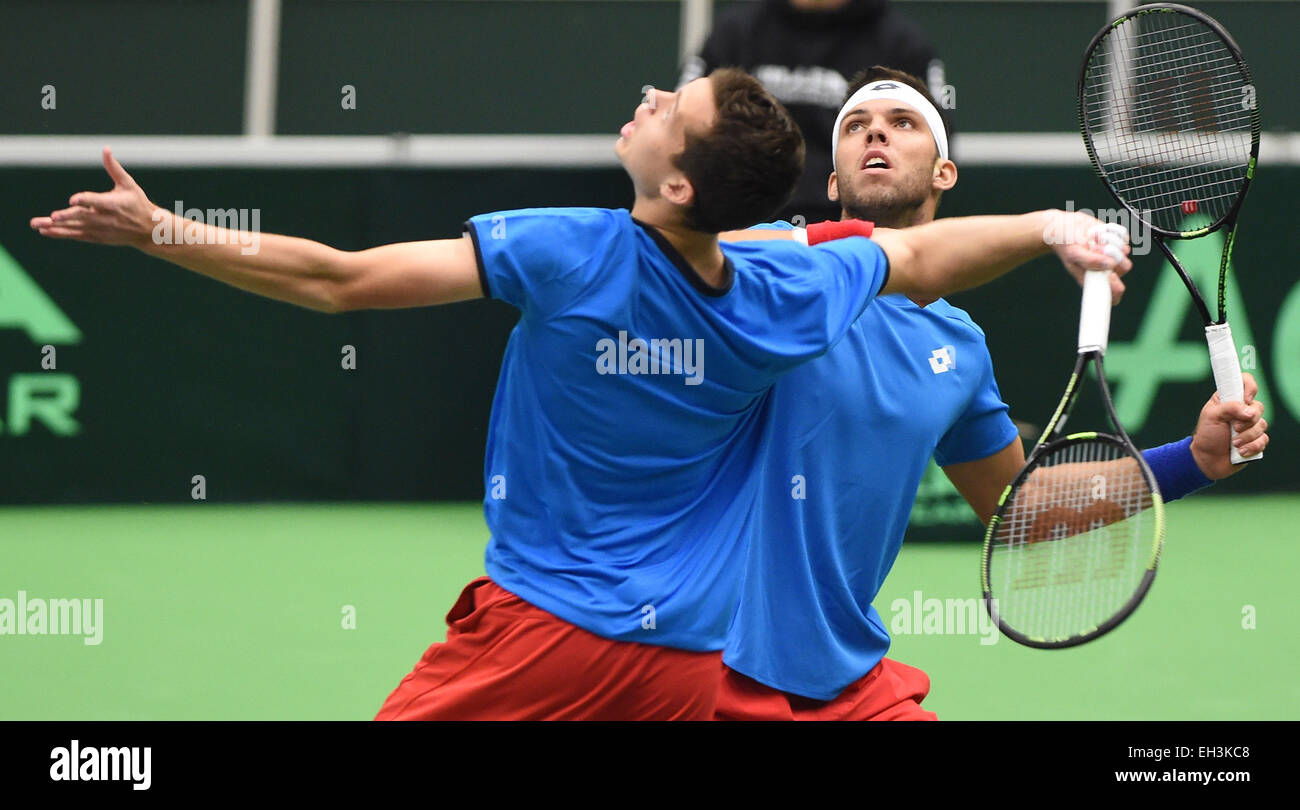 Adam Pavlasek, left, returns a ball as his partner Jiri Vesely, right ...