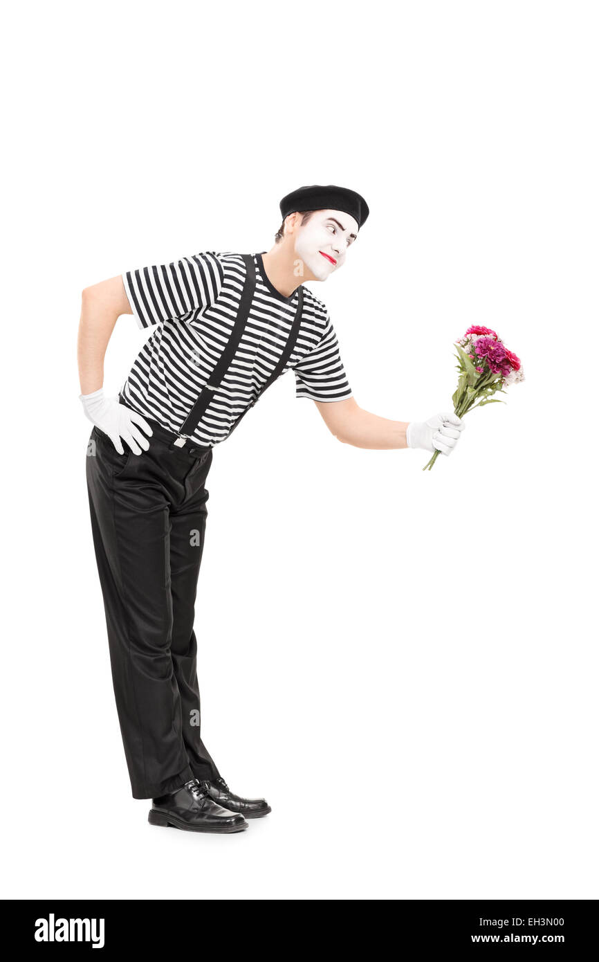 Full length portrait of a mime artist giving flowers to someone ...
