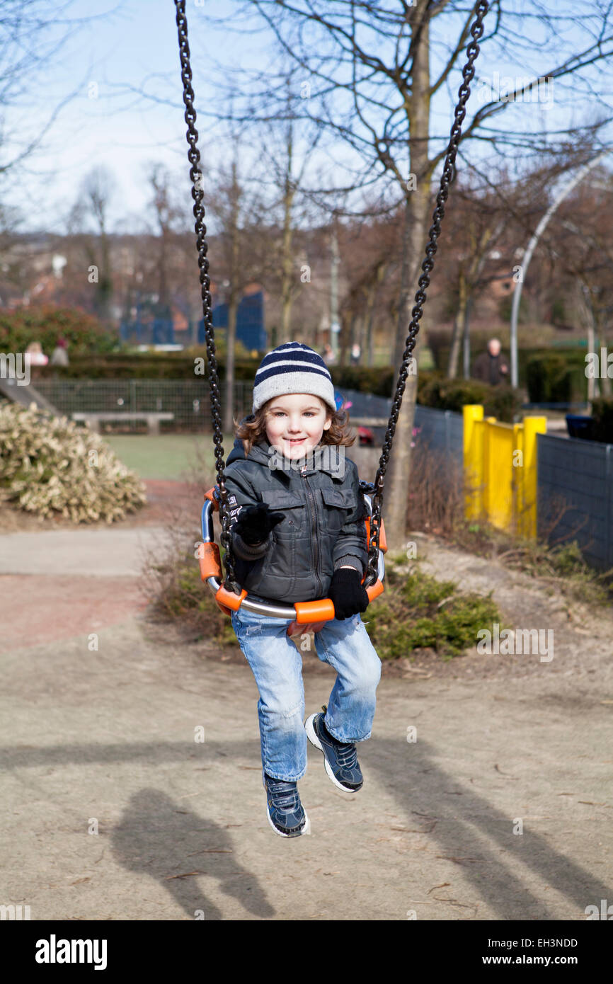 Toddler on a swing in a playground Stock Photo - Alamy