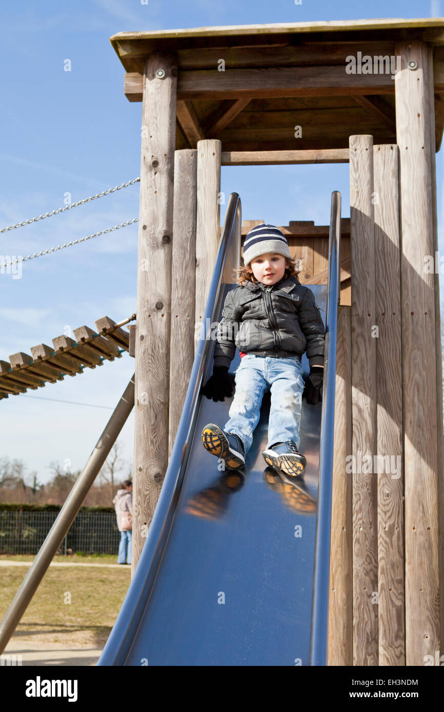 Kid sliding on slide hi-res stock photography and images - Alamy