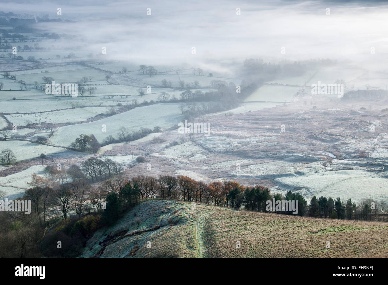 Mist over frosted fields on an early winter morning at Castleton in the ...