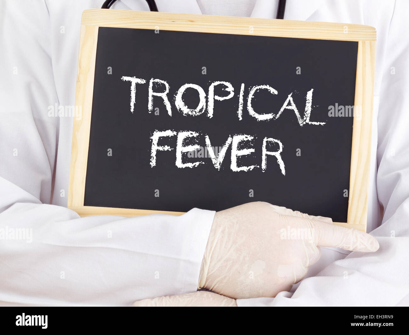 Doctor shows information on blackboard: Tropical fever Stock Photo - Alamy