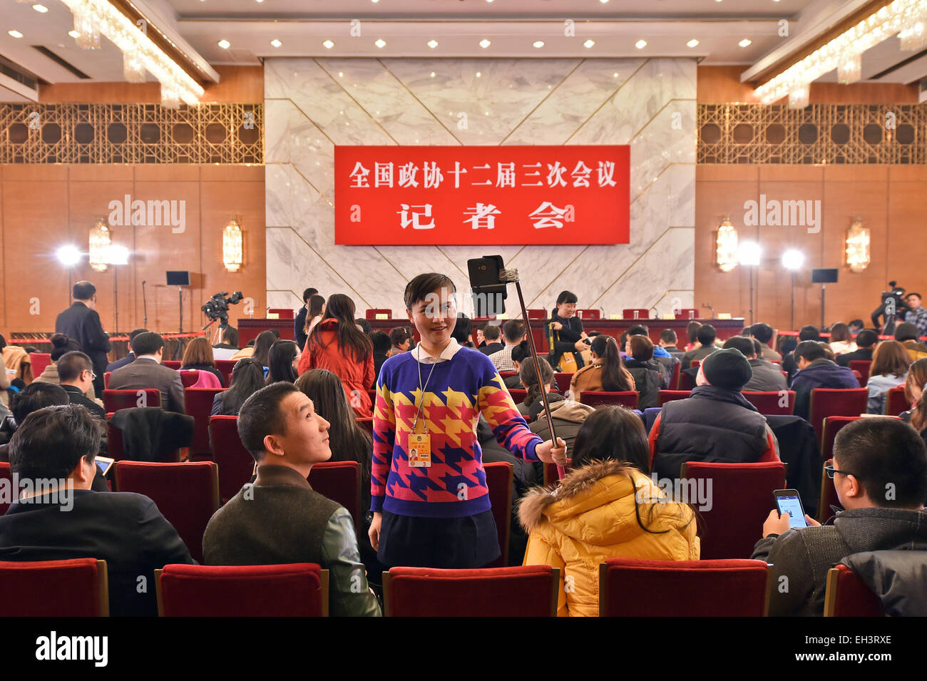 Beijing, China. 5th Mar, 2015. A journalist uses a "selfie stick" to ...