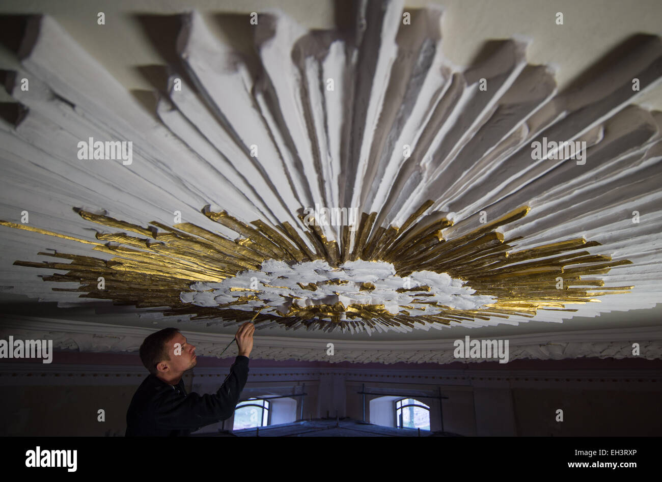 Restorer Andre Baer paints the stuccoed ceiling of the palace chapel ...