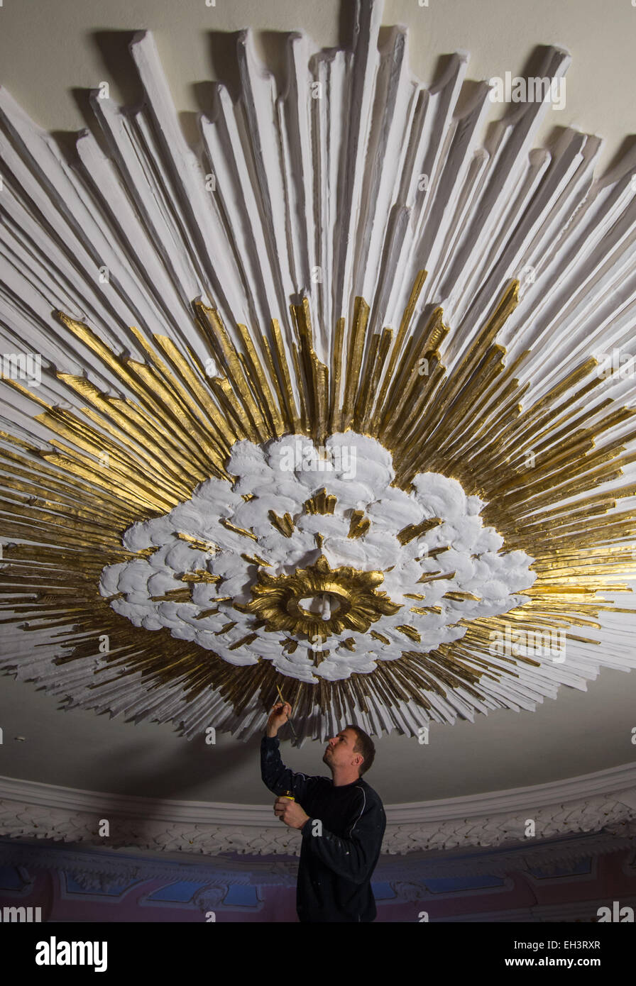 Restorer Andre Baer paints the stuccoed ceiling of the palace chapel ...